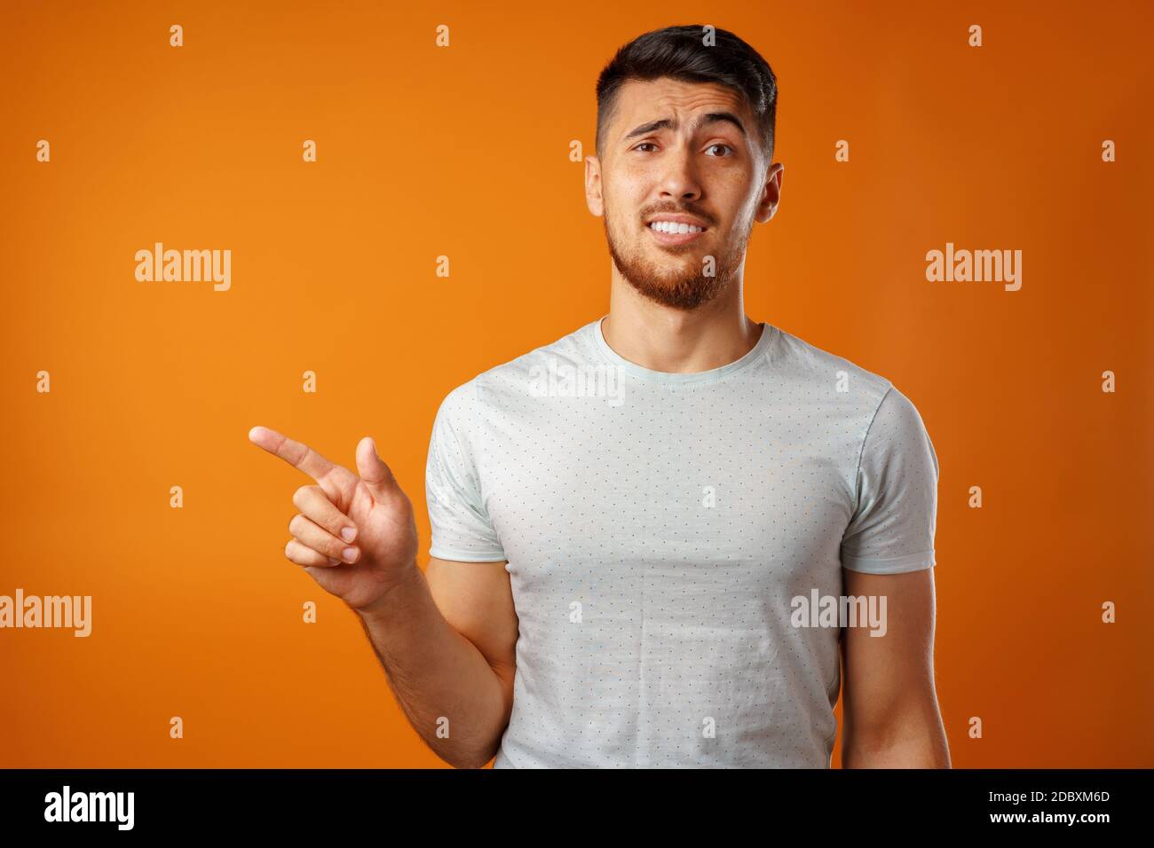 Young handsome man standing and pointing fingers to the side Stock ...