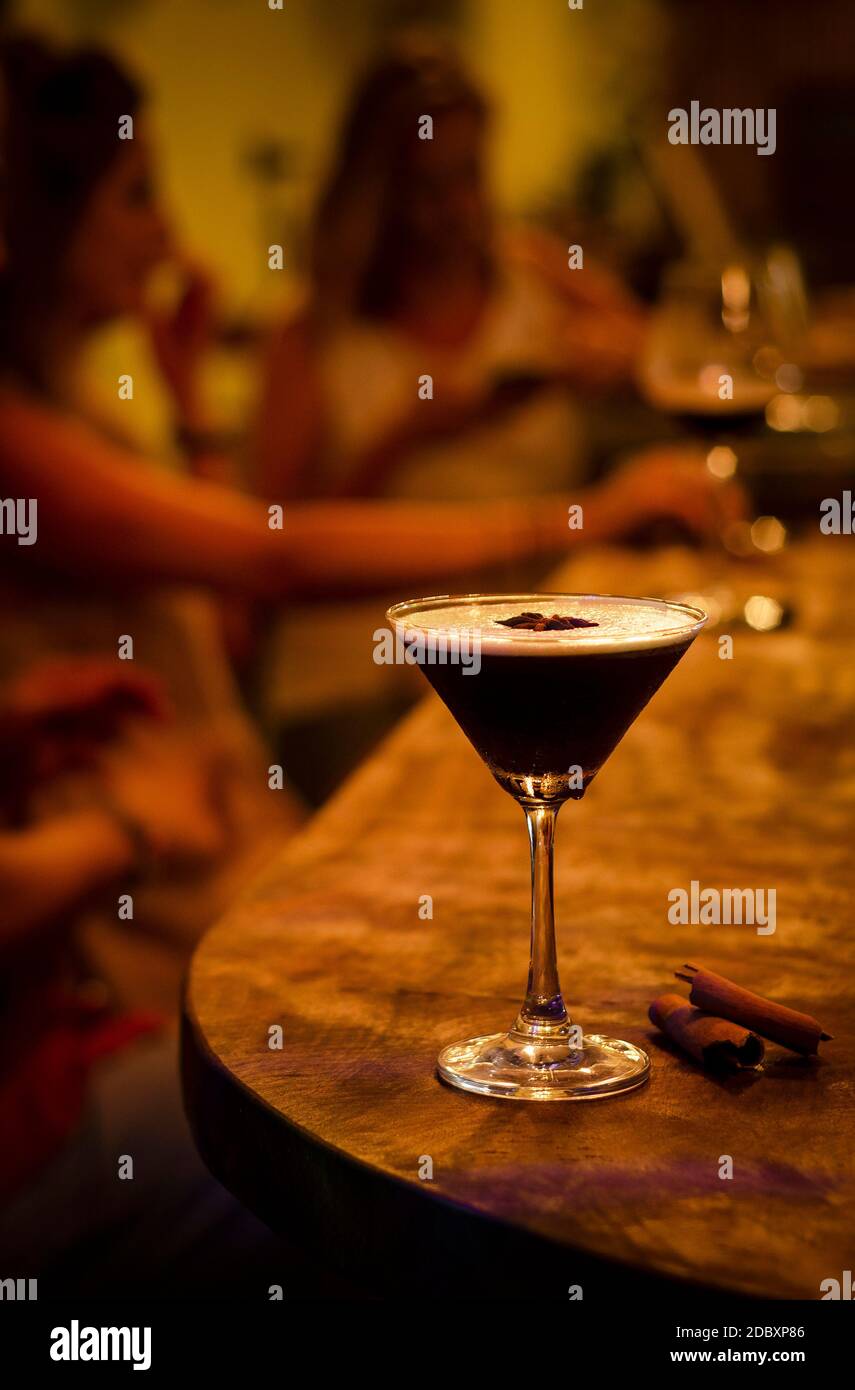 espresso martini cocktail drink in cozy dark bar interior at night ...