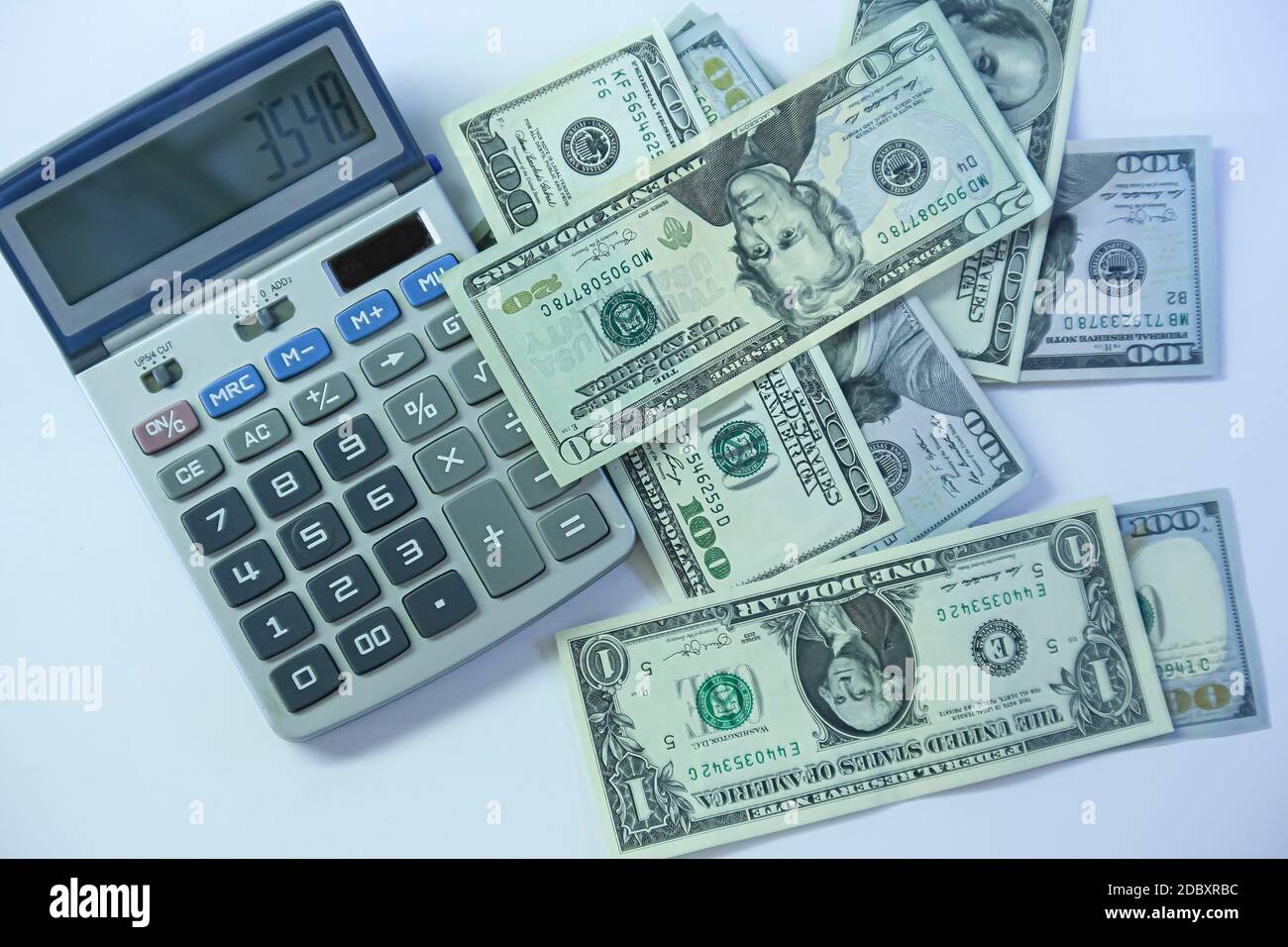 Dollar notes and calculator in office on white background Stock Photo ...