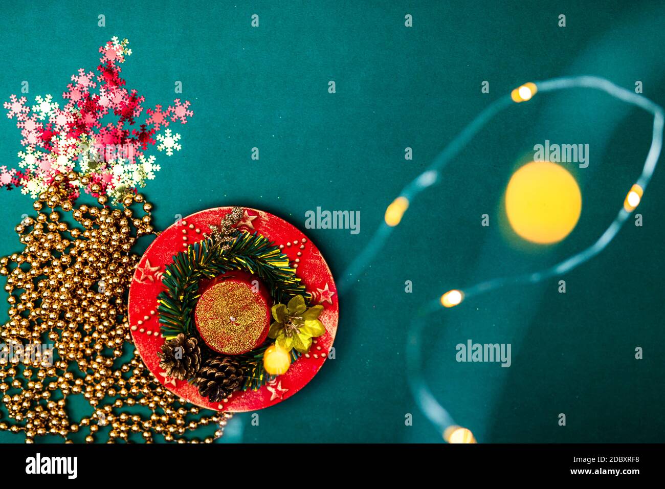 Christmas lights over a december season composition with ornaments and ...