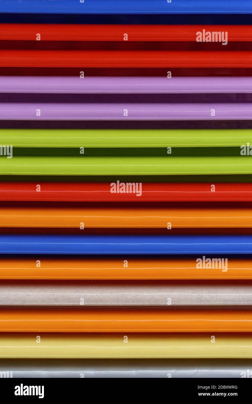 Stacked colourful plastic parts repetitive pattern Stock Photo - Alamy