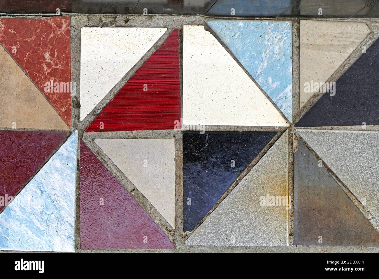 Grunge floor tiles made from triangular pieces Stock Photo - Alamy