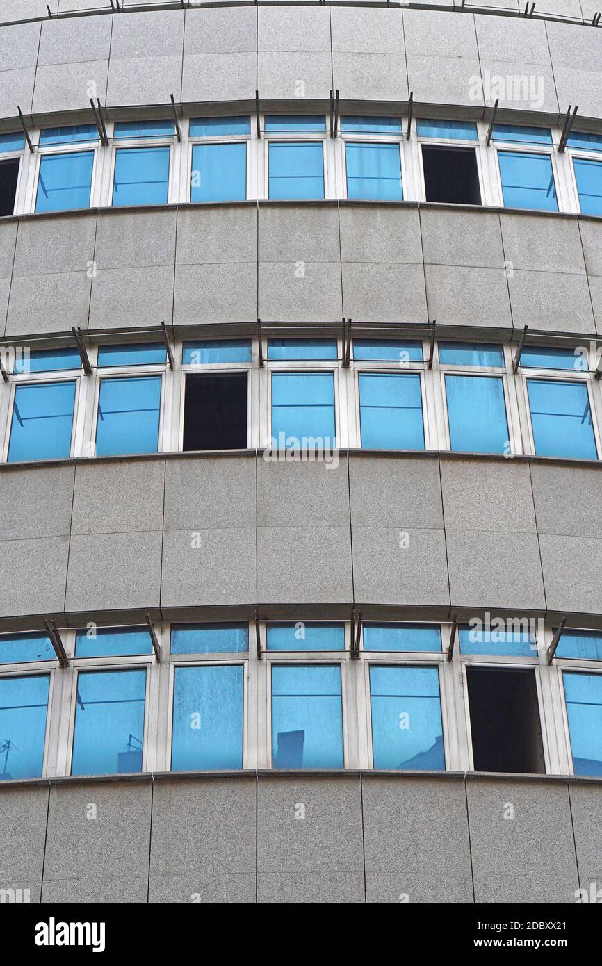 Blue windows at modern gray building Stock Photo - Alamy
