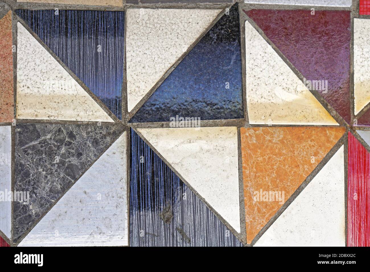 Grunge floor tiles made from triangular pieces Stock Photo - Alamy