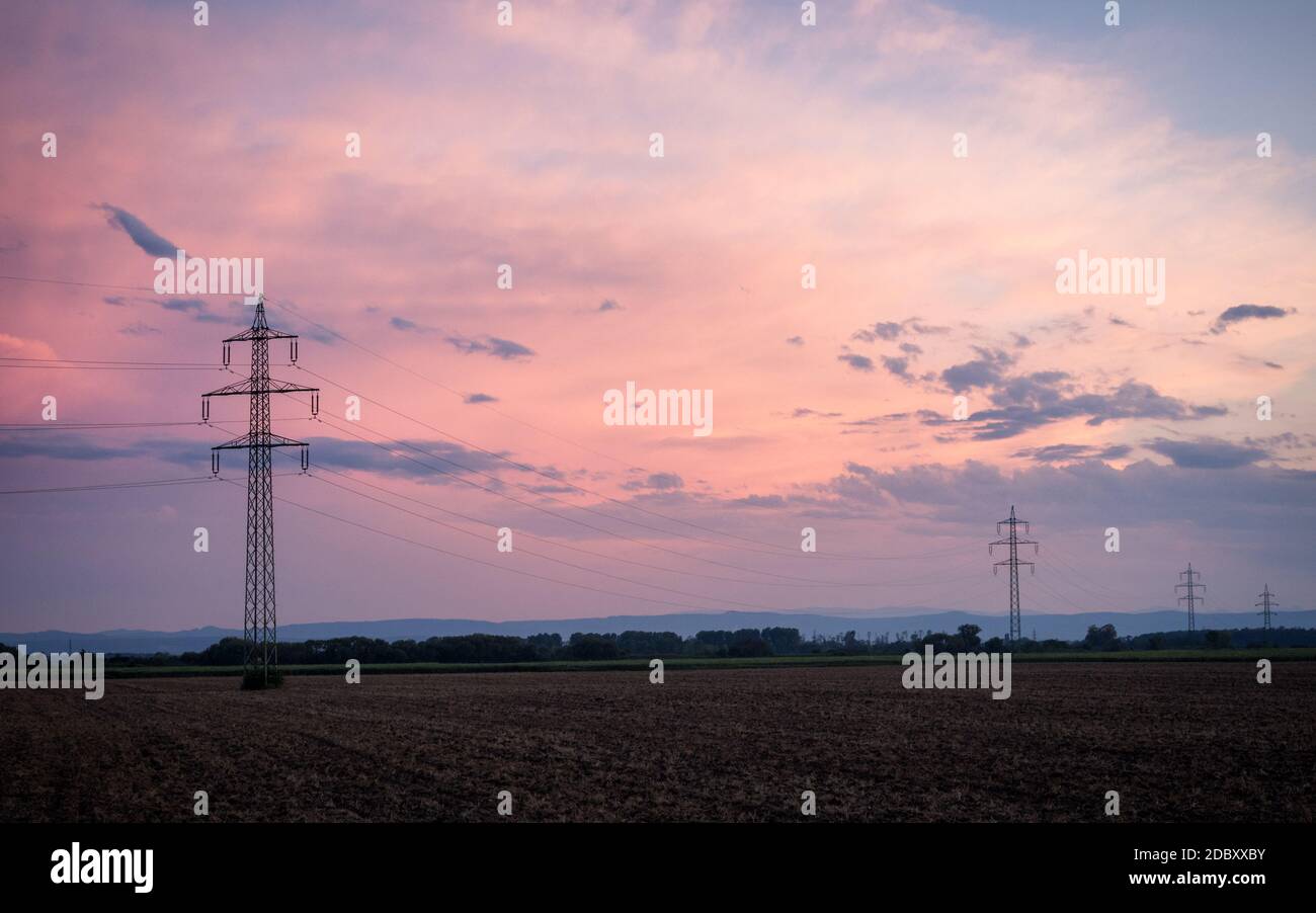 Pink sky and cable pylons in Burgenland Stock Photo - Alamy