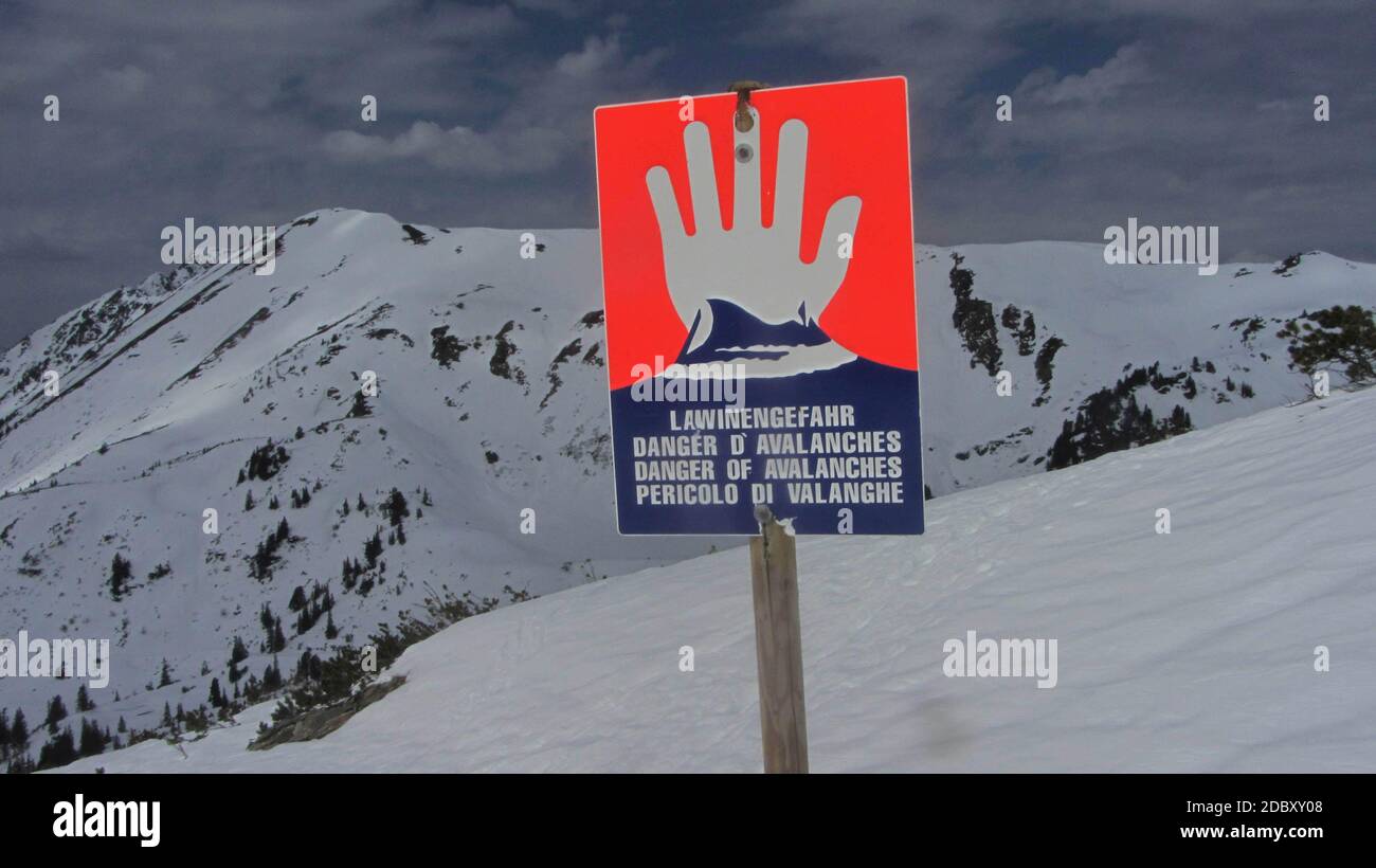 red danger of avalanches warning sign on snowy mountain - in german ...