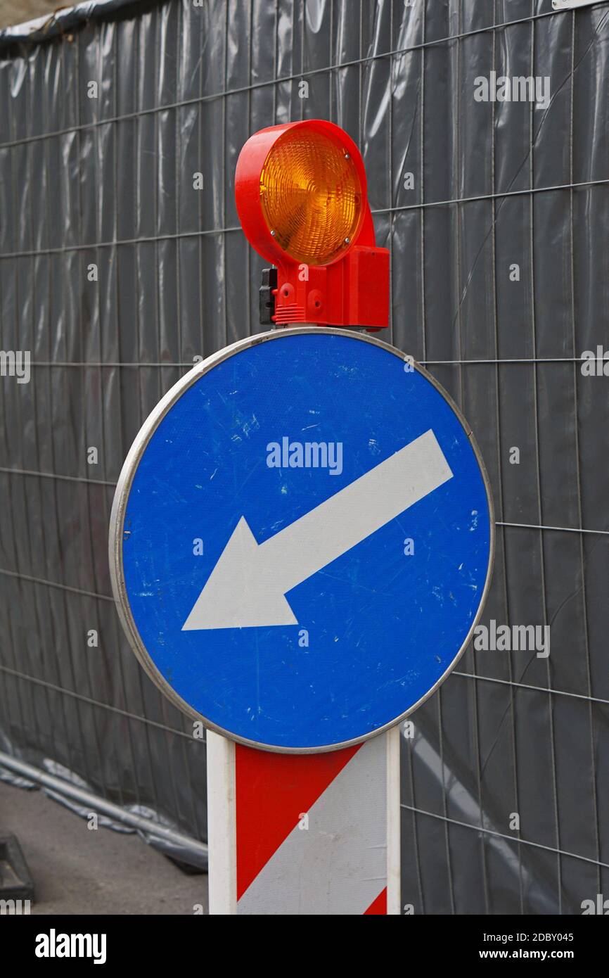 Direction arrow sign and safety light Stock Photo - Alamy