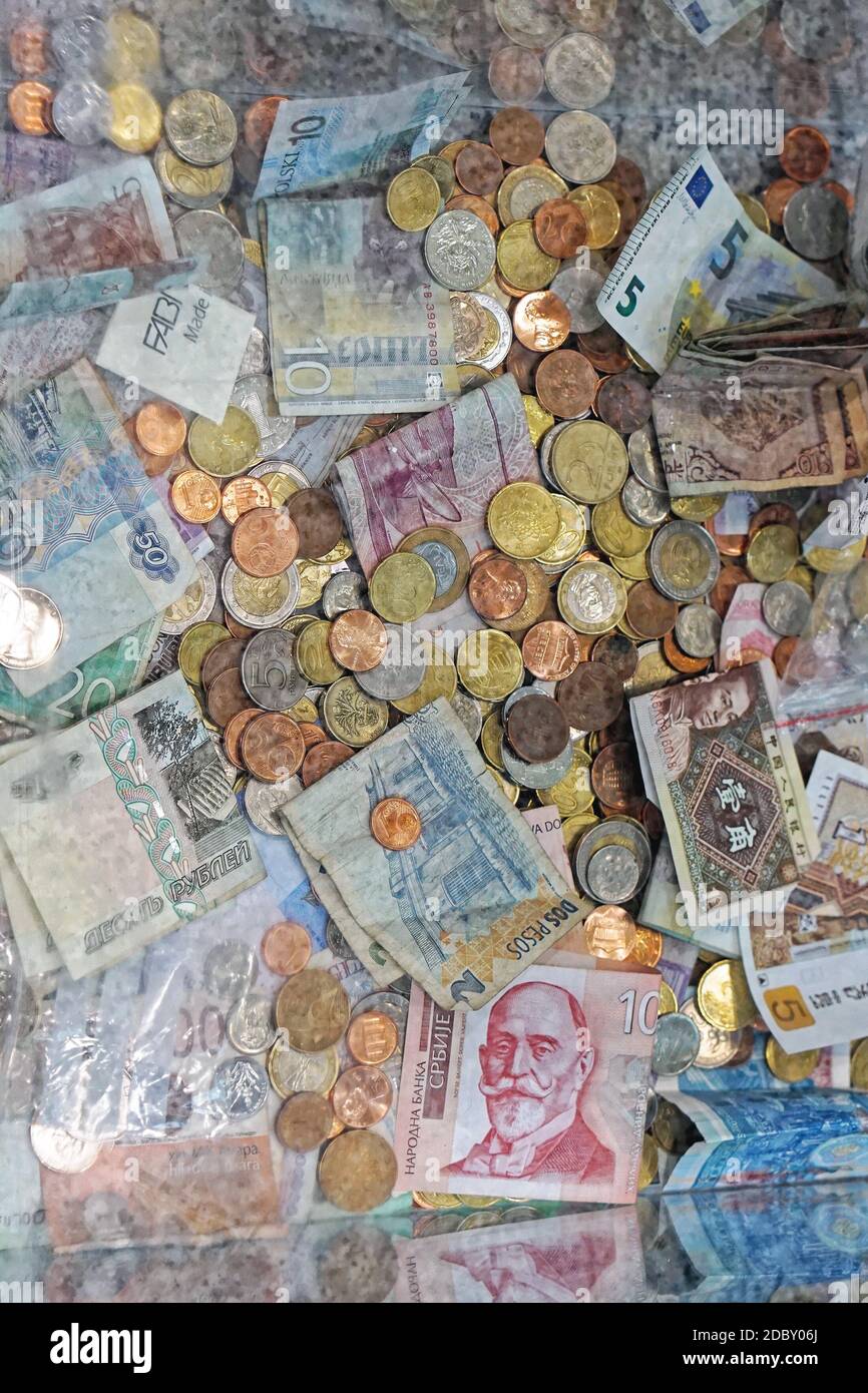 Mix coins and banknotes currency in clear donation money box Stock ...