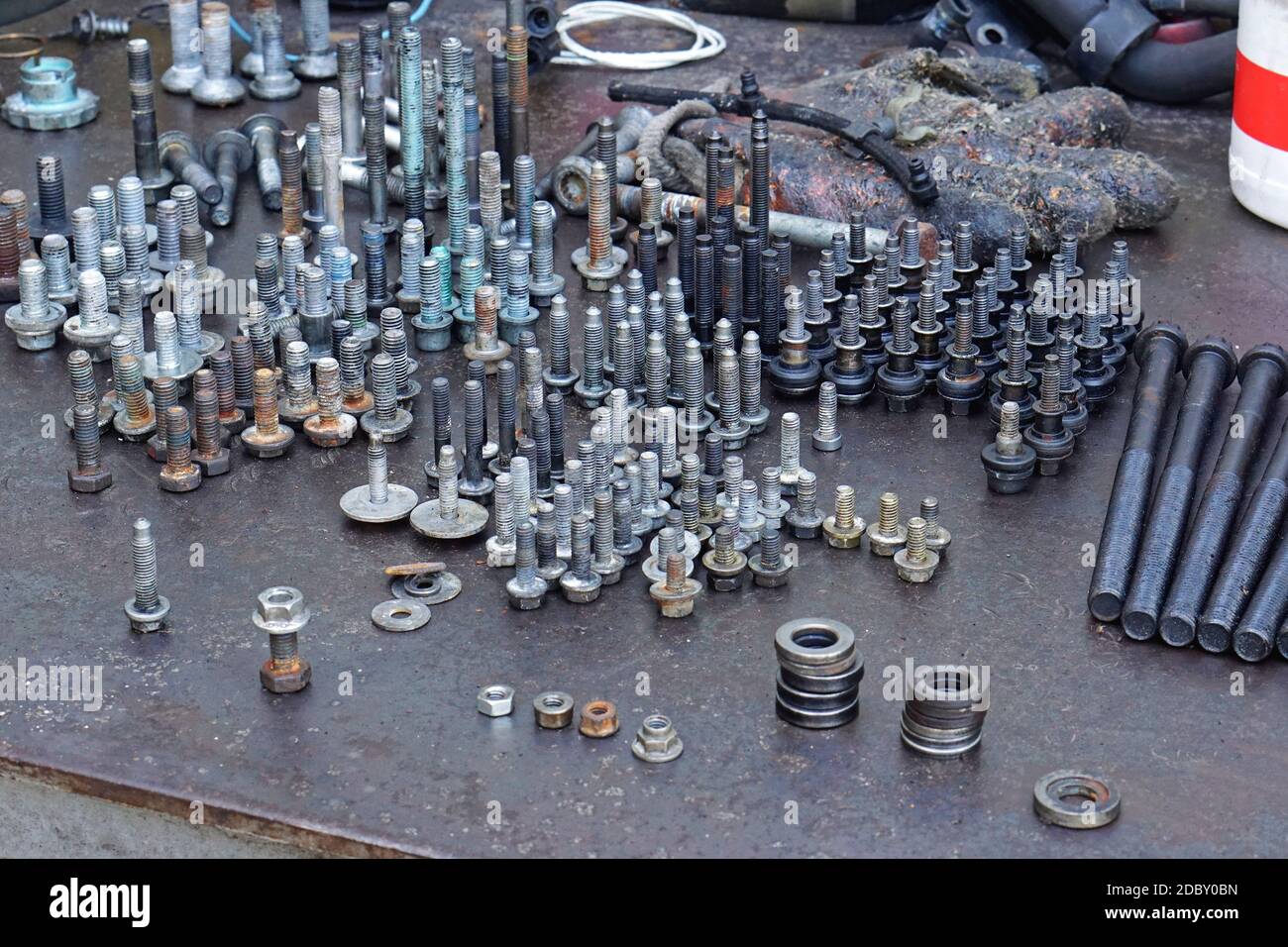 Screws bolts and nuts in upright position at work bench Stock Photo - Alamy