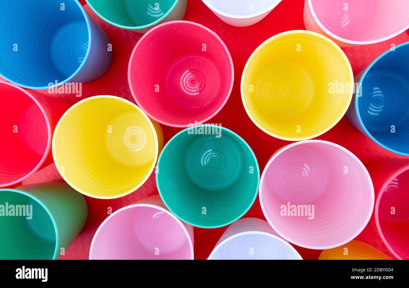 Colorful plastic mugs in detail as background Stock Photo - Alamy