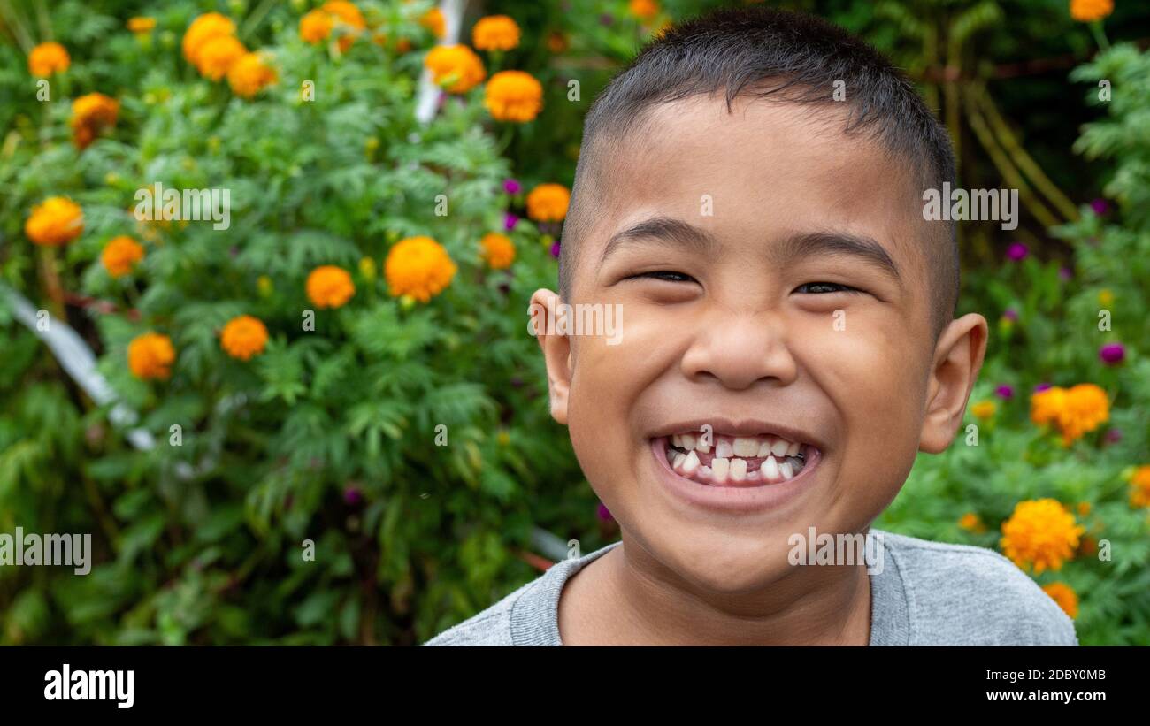 Boy smiling face portrait On a garden background Stock Photo - Alamy