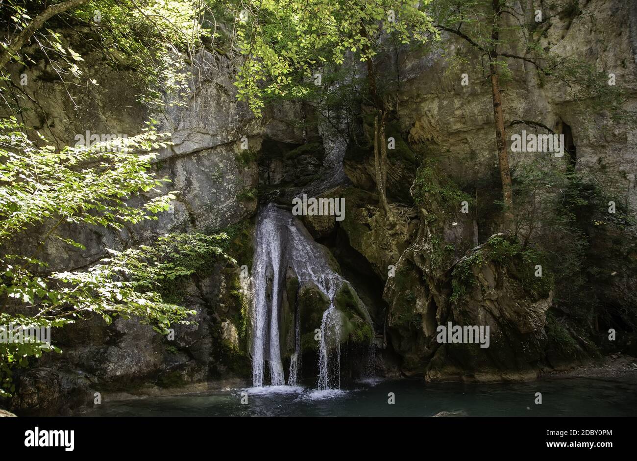 Spring water falling into a beautiful natural waterfall Stock Photo - Alamy