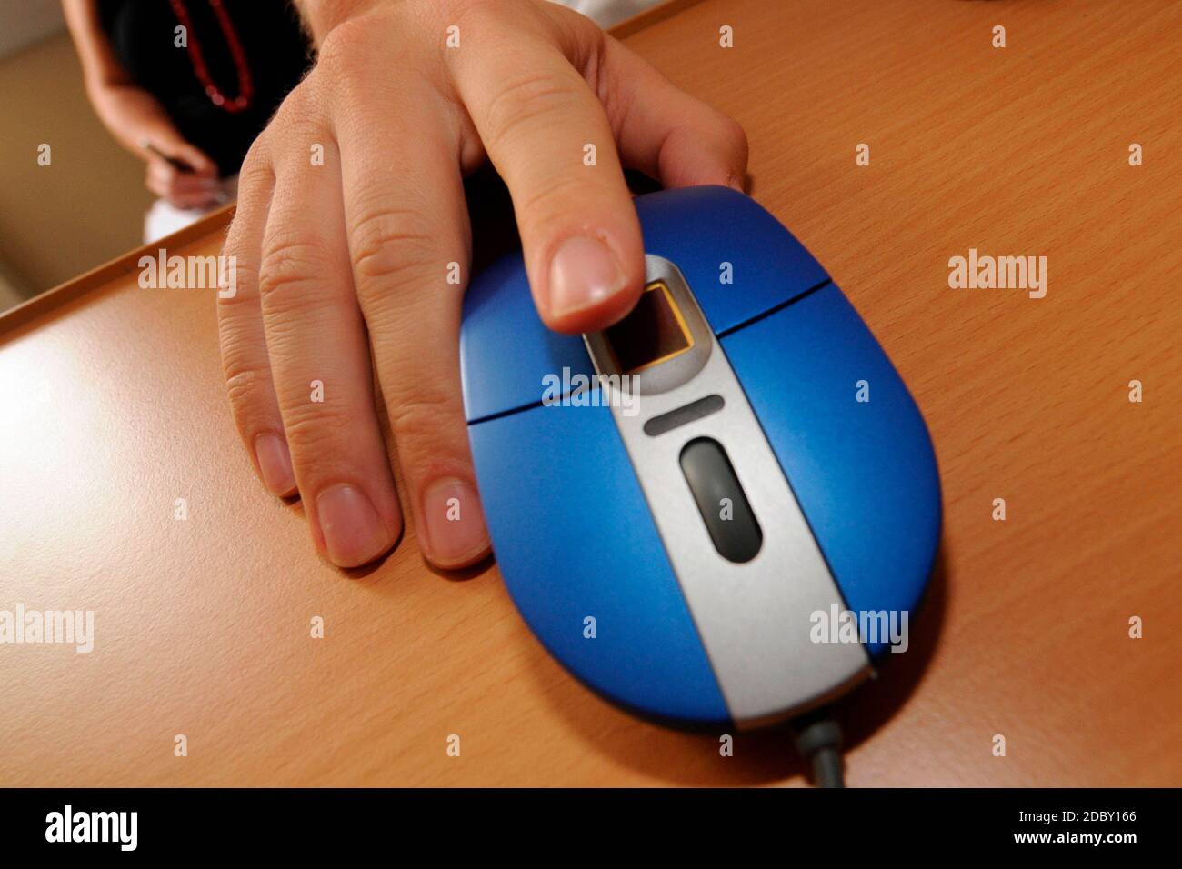 hand touching the finger sensor of a blue computer mouse Stock Photo ...