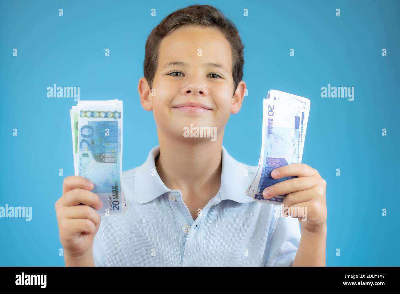 Surprised little boy with money cash. Cute kid hiding face behind fan ...