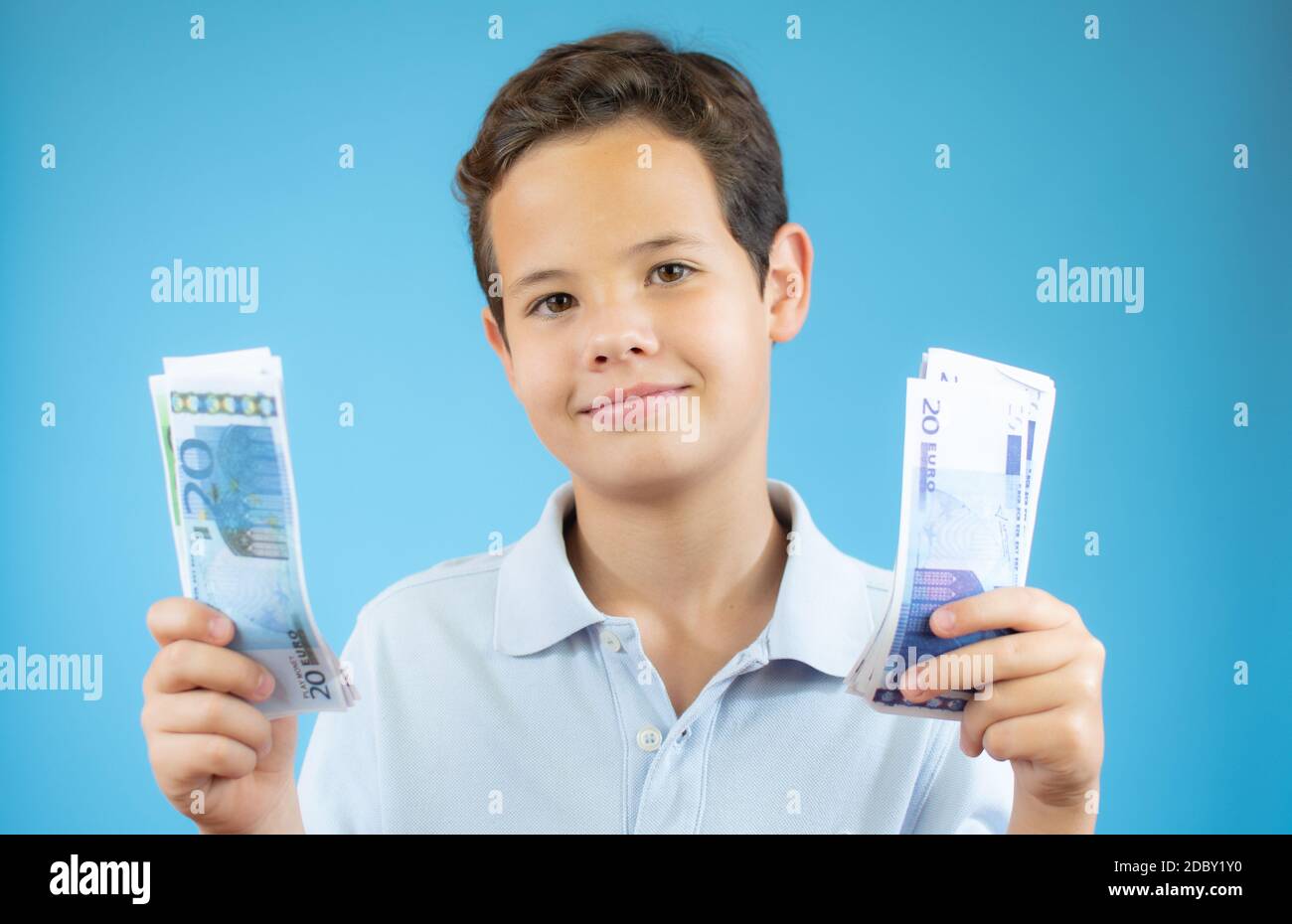 Surprised little boy with money cash. Cute kid hiding face behind fan ...