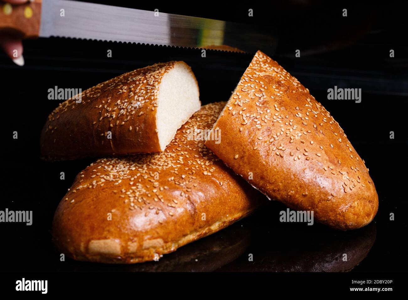 Homemade pastries. Crispy white bread cut with a knife. Photo on a ...