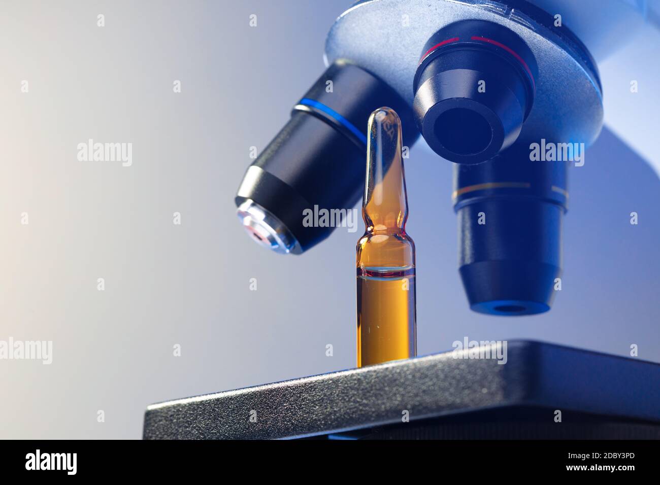 Medical vial with medication near microscope close up Stock Photo - Alamy