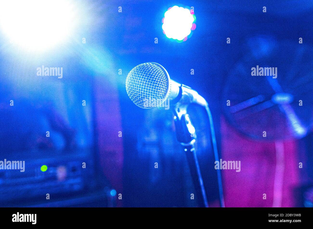 vocal microphone in a set of spotlights on a concert stage in a club ...