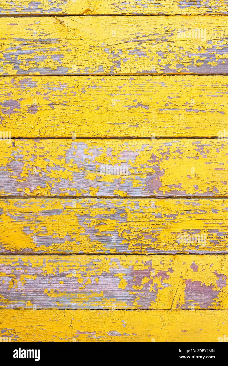 Old wooden shabby yellow background or texture, part of rustic fence or ...