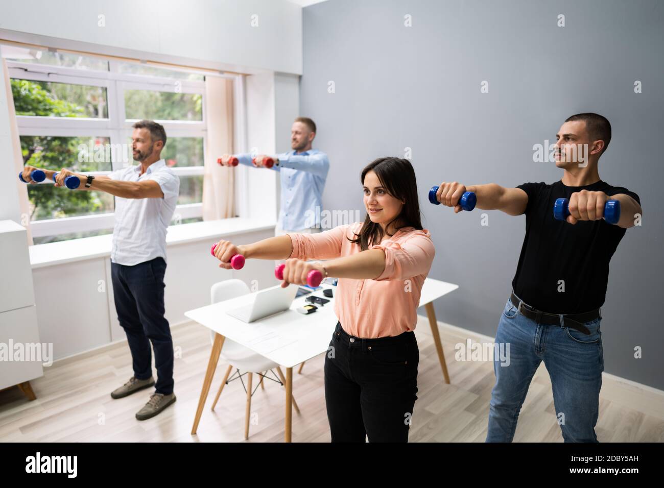 Office Wellness Exercises For Group Of Diverse People Stock Photo - Alamy