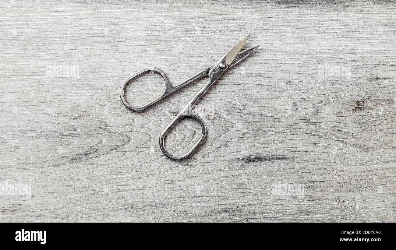 Manicure cuticle scissors on laminate flooring that looks like white ...