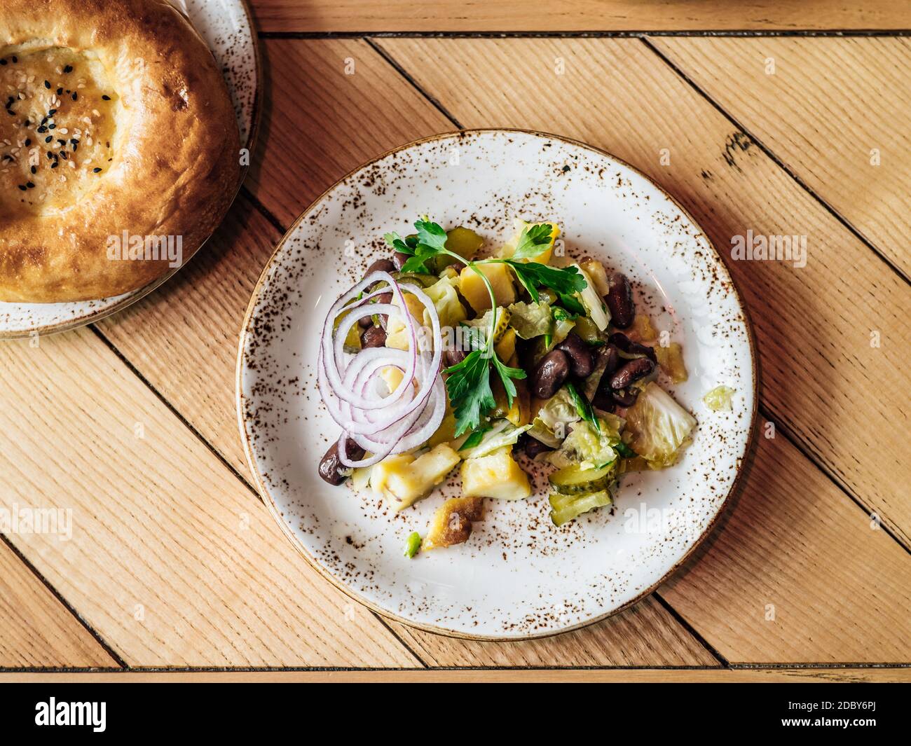 Authentic shot of georgian style salad with red beans, potatoes, salted ...