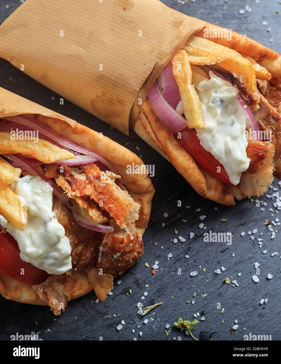 Gyro wraps greek food. Grilled meat sliced with fried potatoes, tomato ...