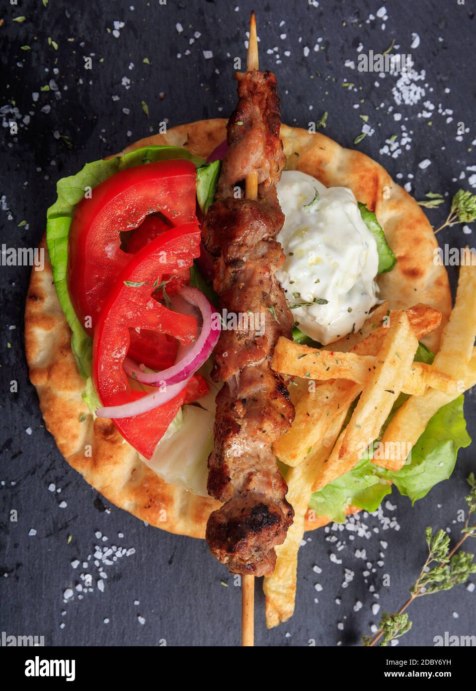 Souvlaki greek food. Grilled meat skewer served with fried potatoes ...