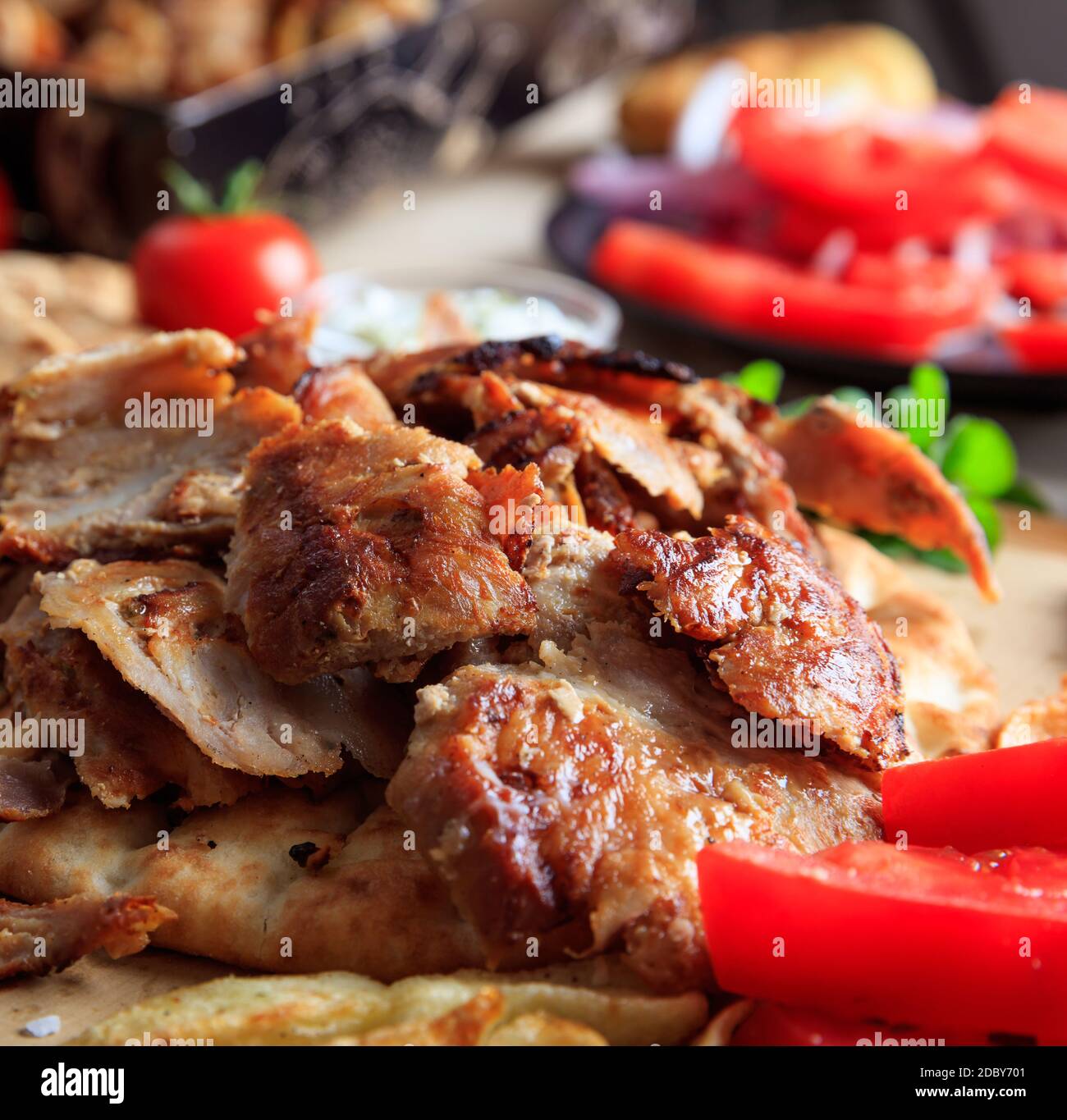 Gyro greek food. Grilled meat slices served with fried potatoes, tomato ...