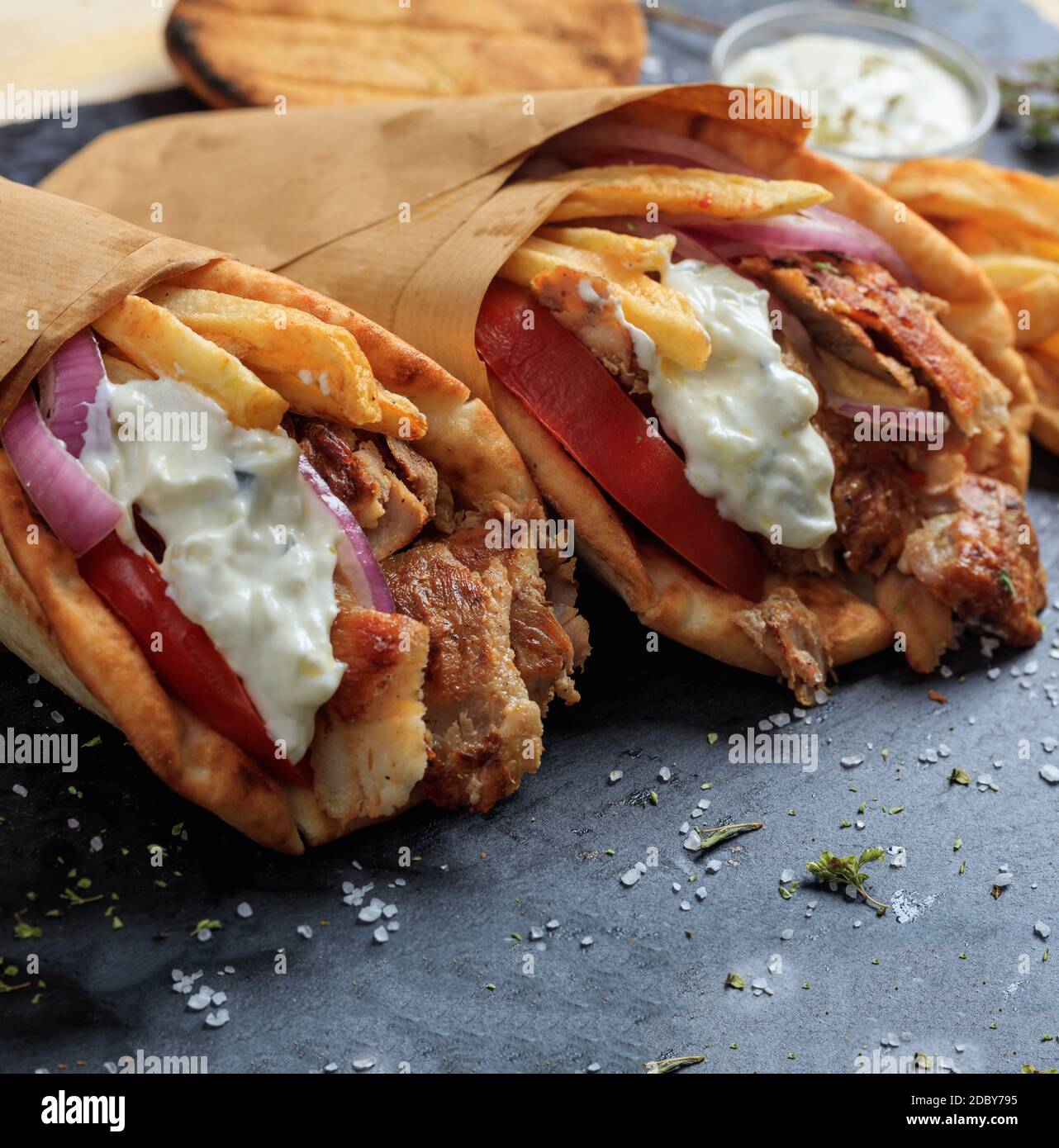 Gyros wraps greek food. Grilled meat sliced with fried potatoes, tomato ...