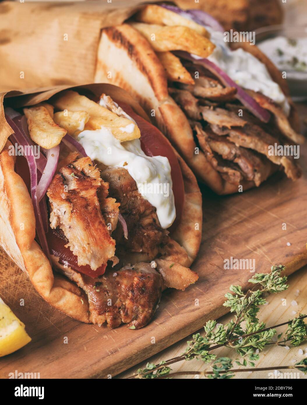 Gyros wraps greek food. Grilled meat sliced with fried potatoes, tomato ...