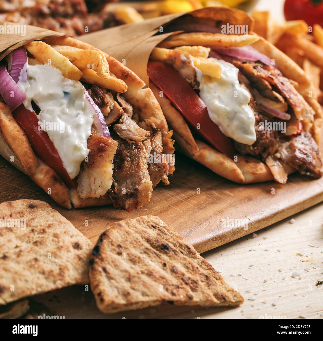 Gyros wraps greek food. Grilled meat sliced with fried potatoes, tomato ...