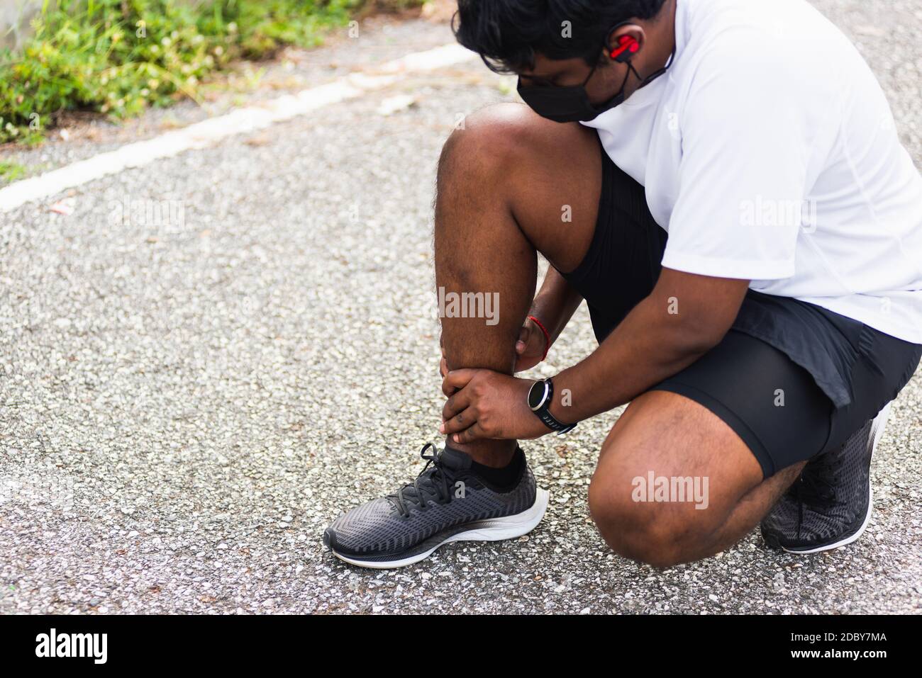 Close up Asian young sport runner black man wear watch hands joint hold ...