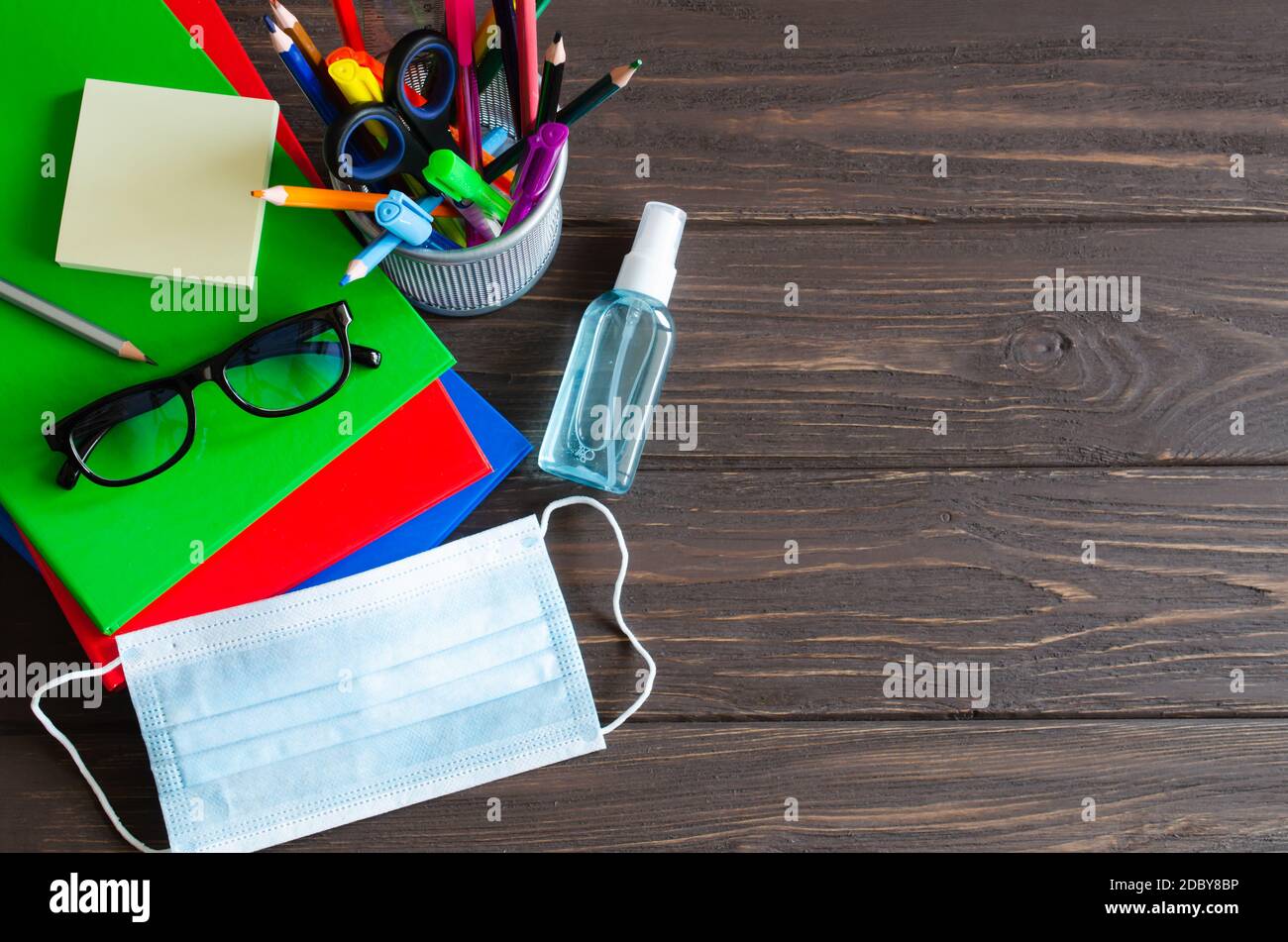 Back to school during quarantine. School supplies with medical mask and ...