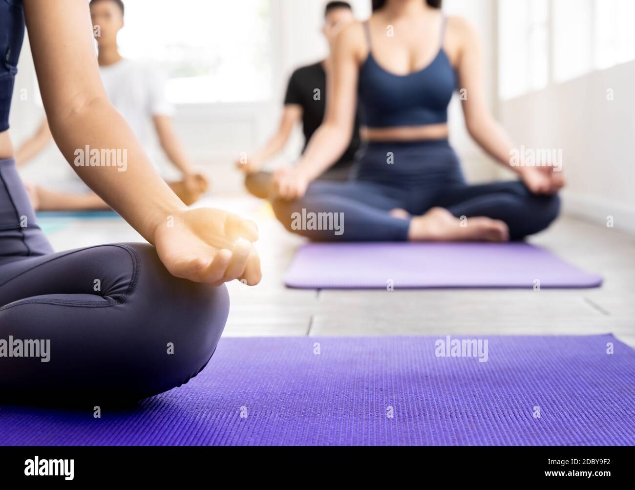 Close up of sporty attractive asian coach on Lotus pose position ...