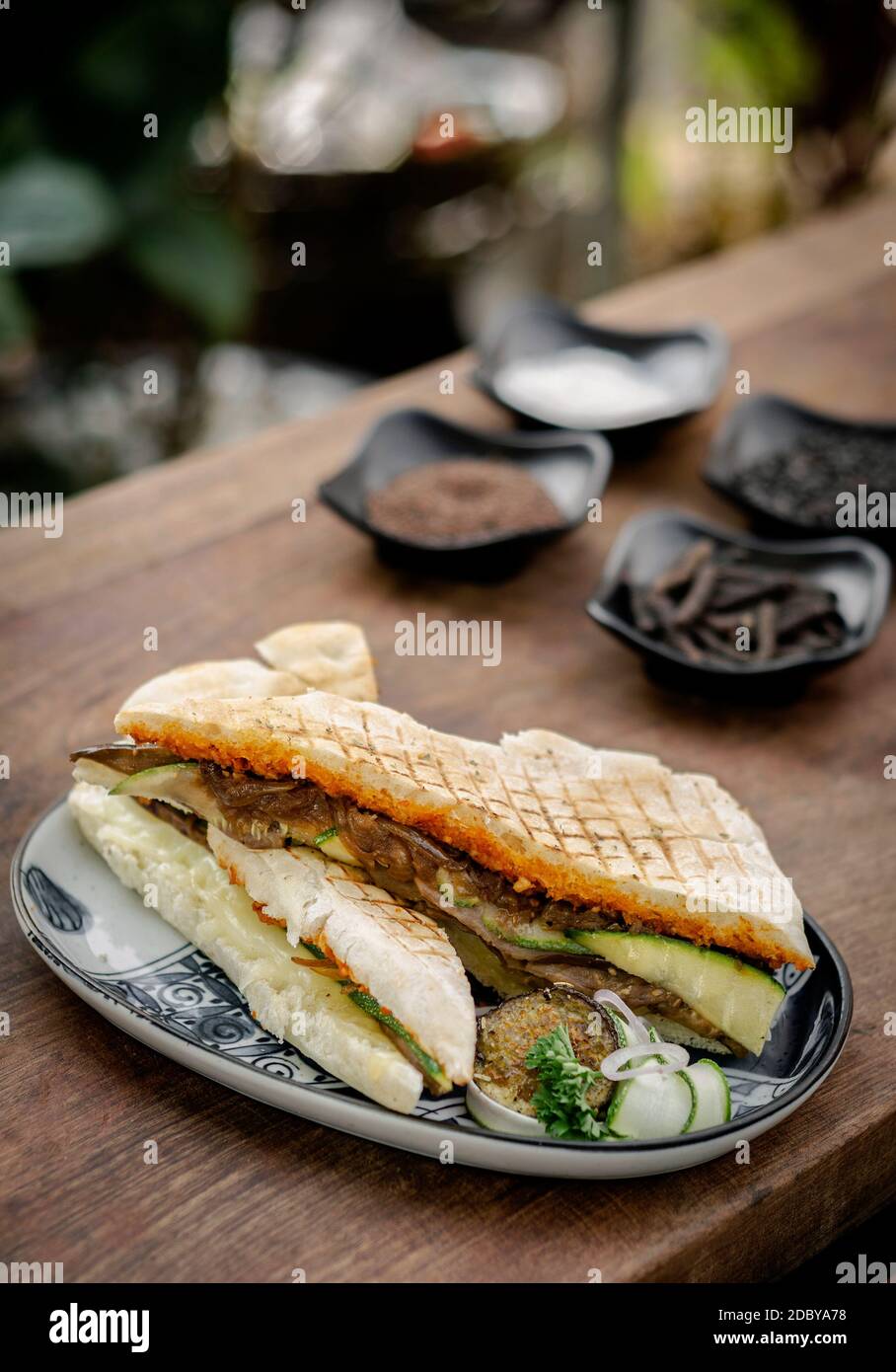 vegan roasted vegetable toasted panini sandwich in rustic garden table ...