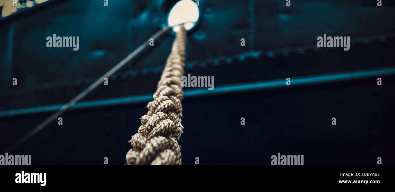 Rope that tied the ship close-up on the background of the ship's side ...