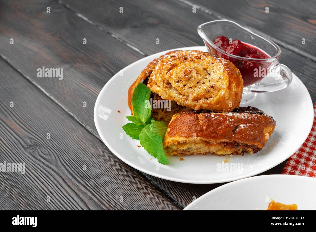 Georgian baked sweet nut roll with berry sauce Stock Photo - Alamy