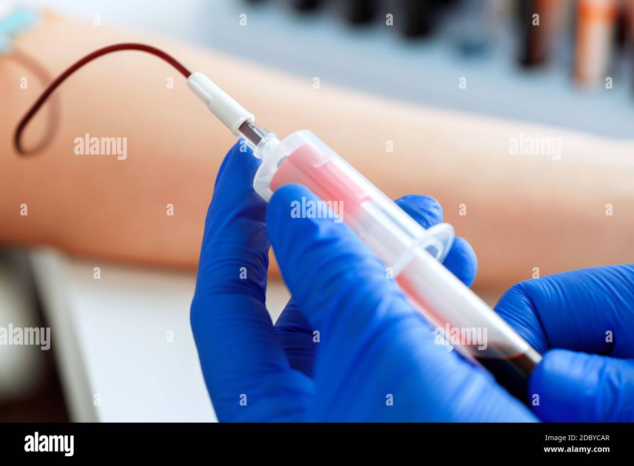 Hands of a doctor taking blood samples using a tube holder Stock Photo ...