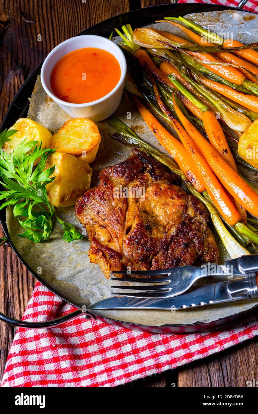 grilled neck chops with caramelized vegetables Stock Photo - Alamy