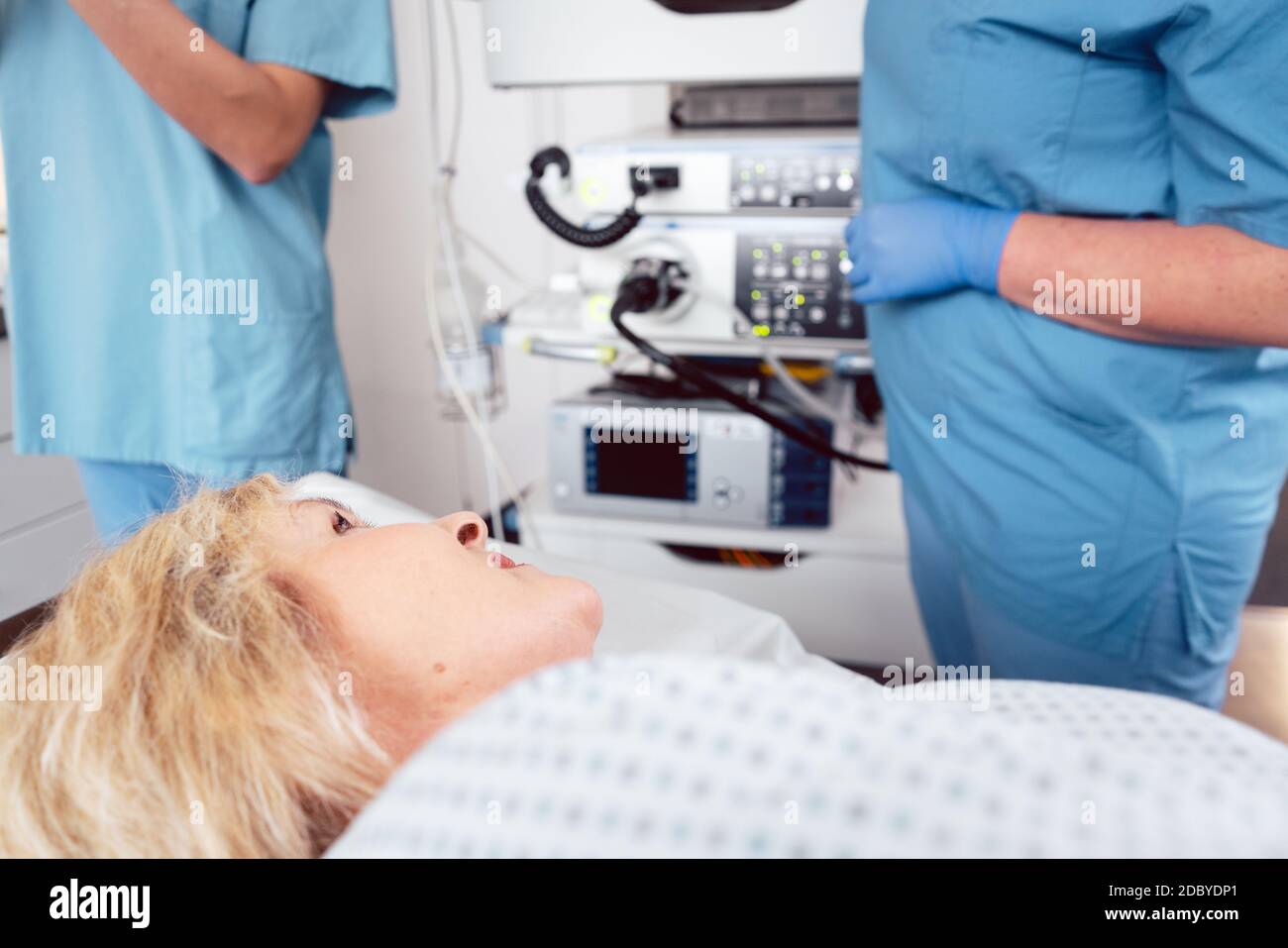 Patient woman in hospital watching nurses preparing for surgery Stock ...