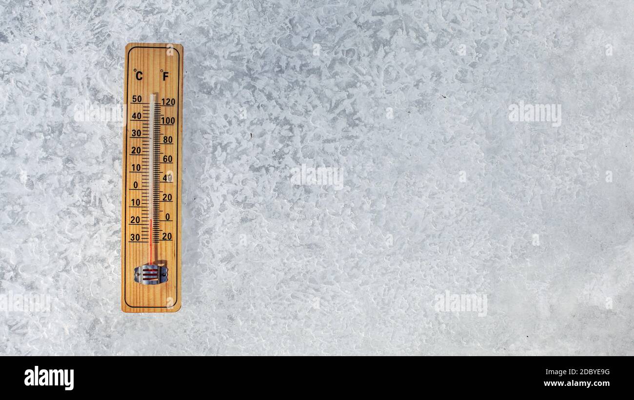 Top view on thermometer laying on layer of ice, showing temperature as ...