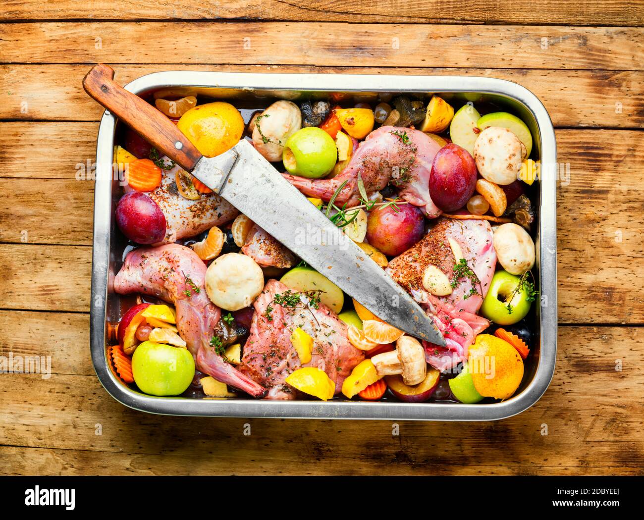 Pieces of raw rabbit meat marinated with fruit Stock Photo - Alamy