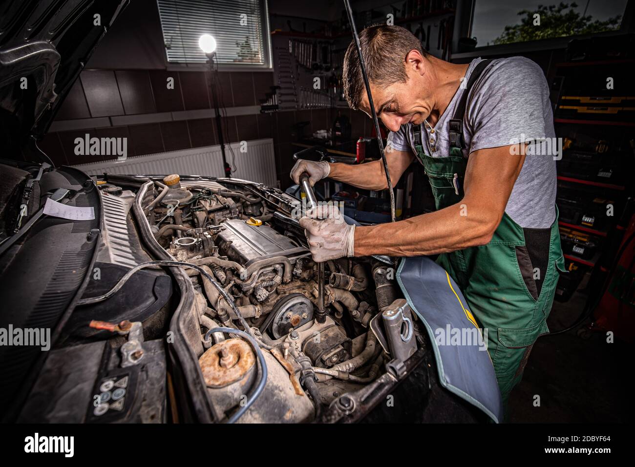 Mechanic with wrench working and repair car engine in car service ...