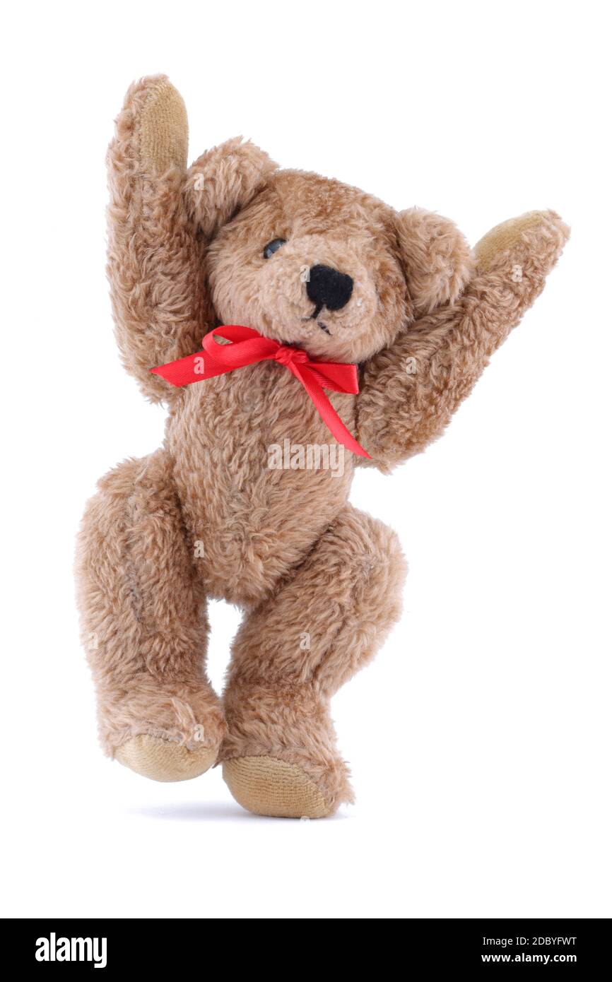 A jumping brown Teddy bear with red ribbon on white background Stock ...