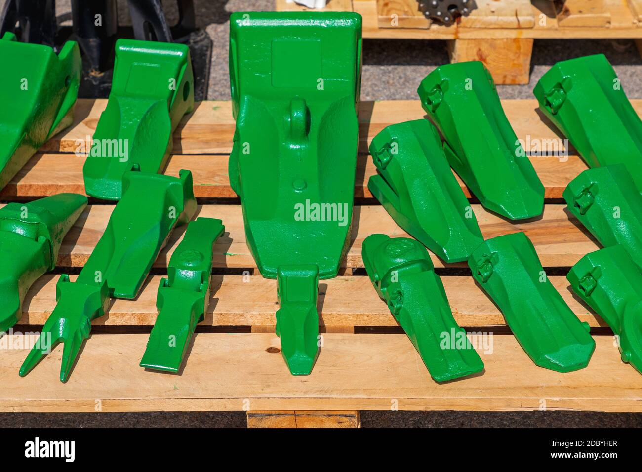 Collection of Green Excavator Bucket Teeth at Pallet Stock Photo - Alamy