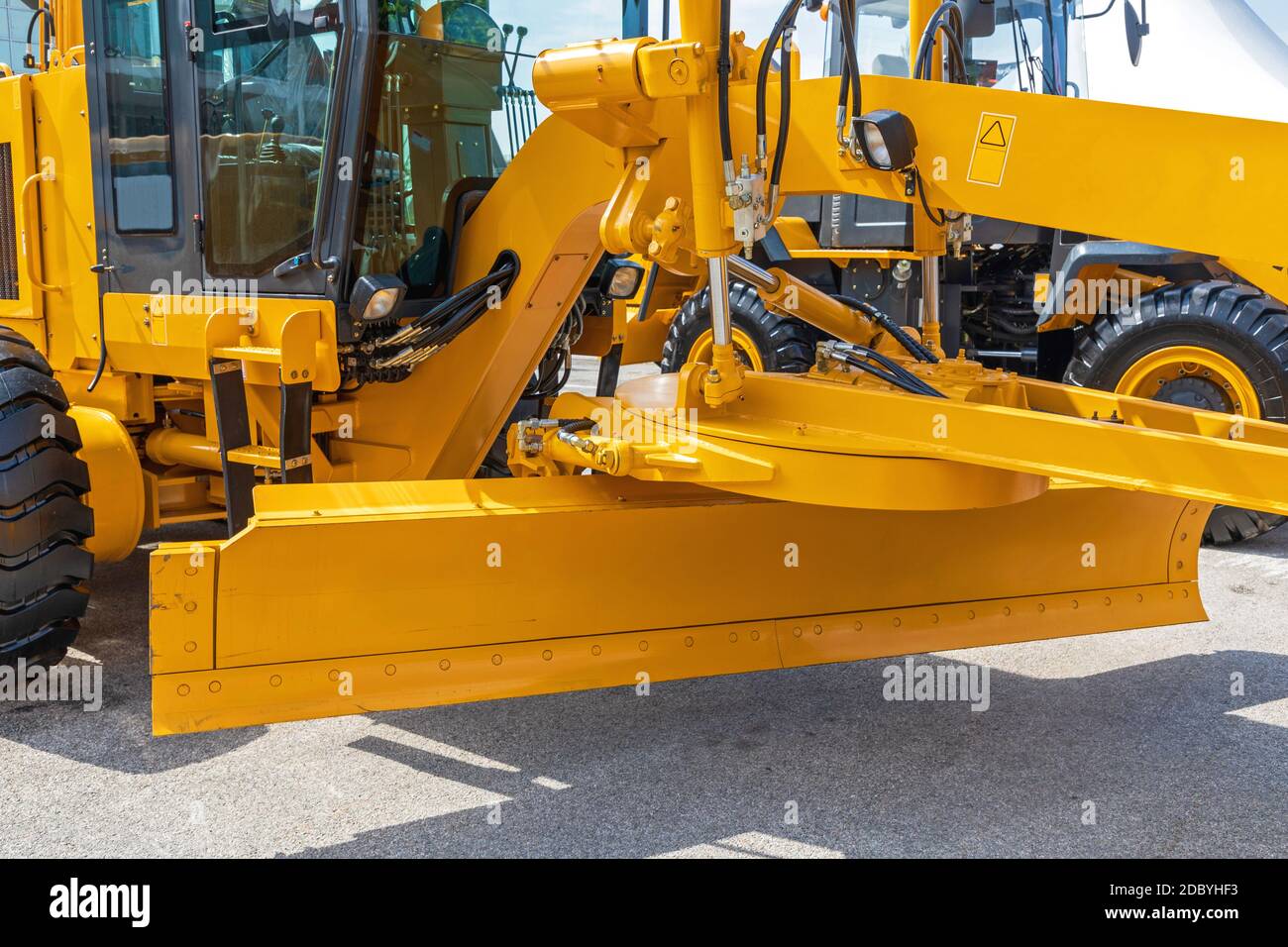 Construction Machine Grader Cleaning and Leveling Blade Stock Photo - Alamy