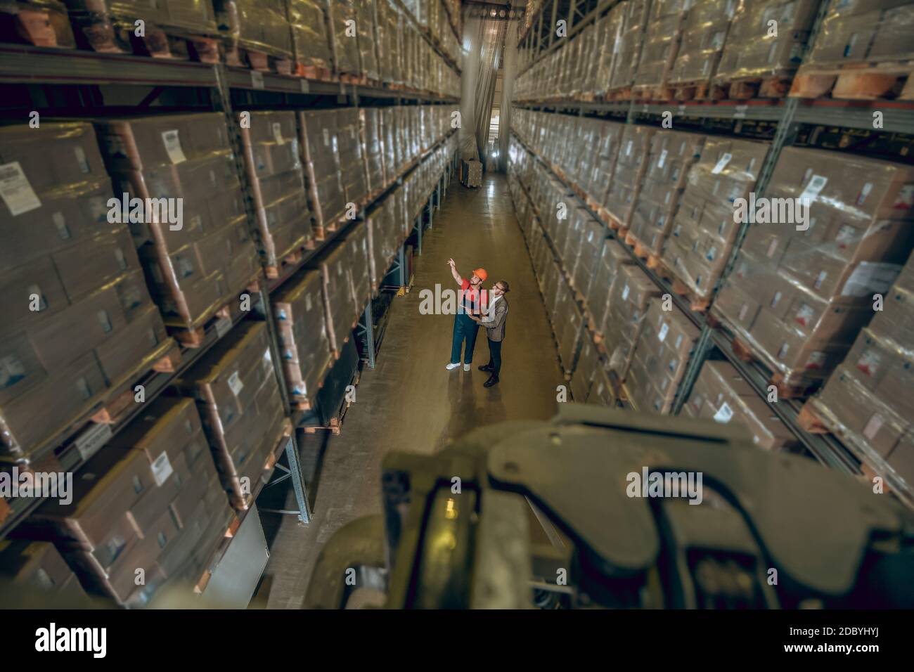 Two people in megastore with lots of containers on the shelves Stock ...