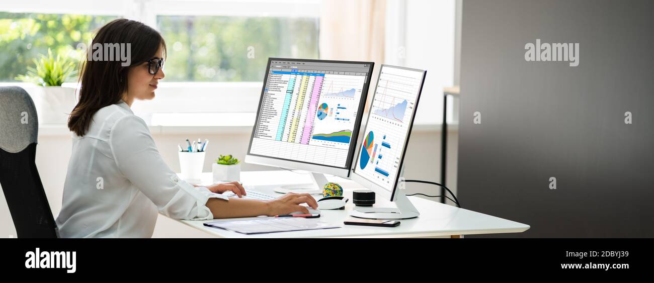 Data Analyst Businesswoman Using PC Computer With Multiple Screens ...