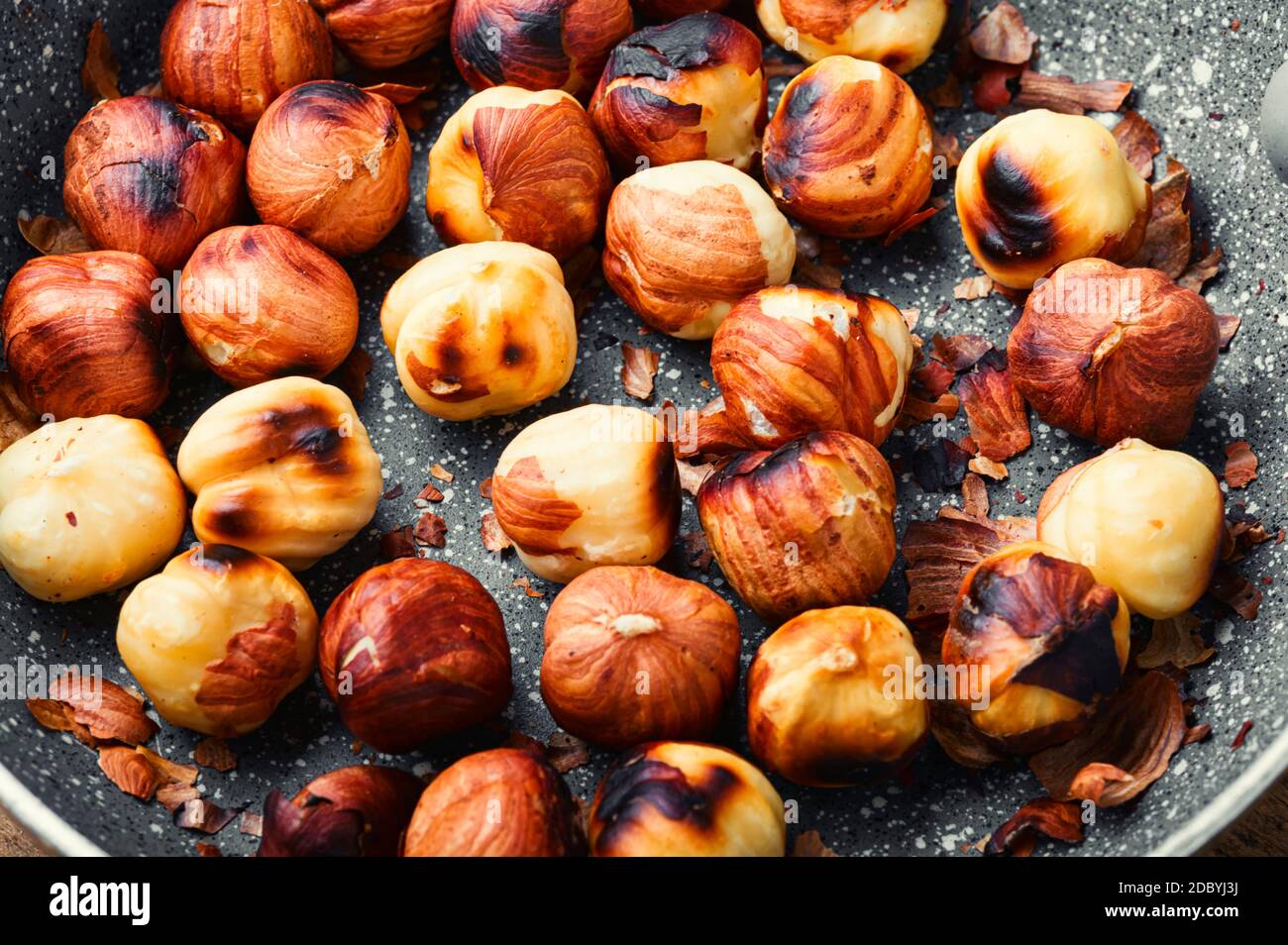 Pile of roasted peeled hazelnuts.Hazelnut fried in a frying pan Stock ...